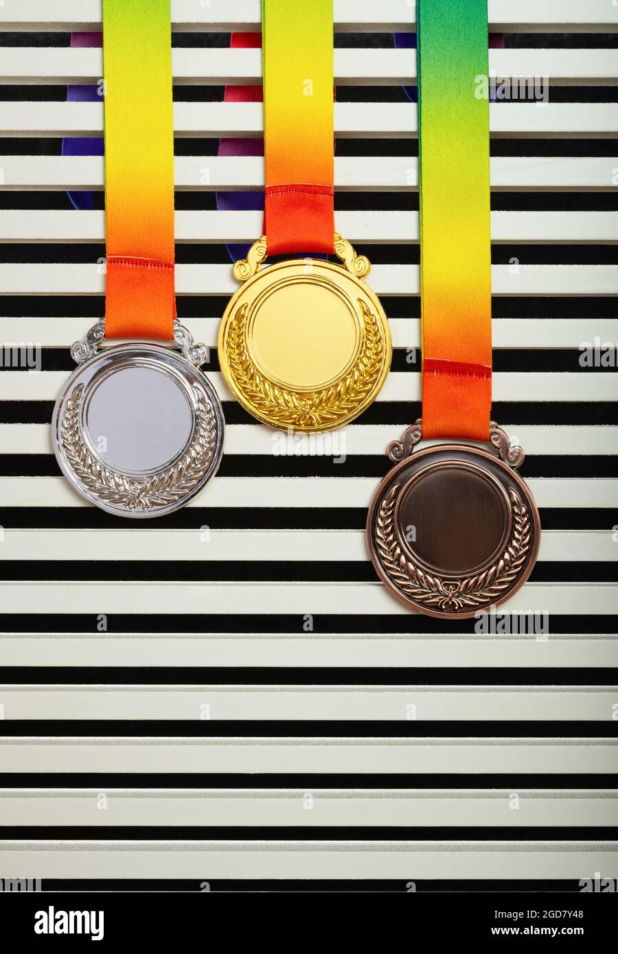 set of gold silver and bronze award medals hanging up vertical ...