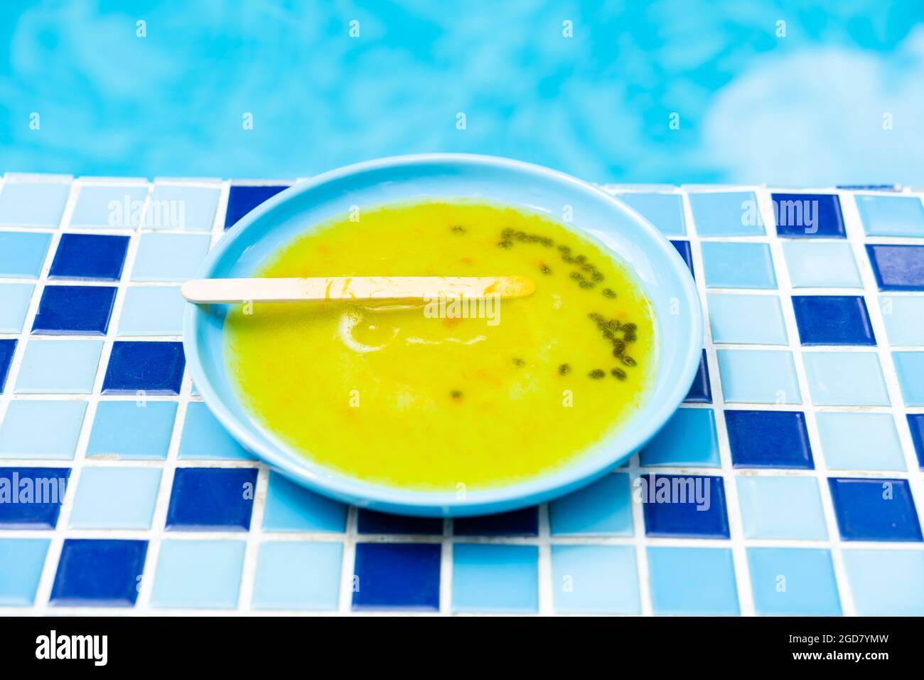 melted passion fruit popsicle in front of a swimming pool Stock Photo ...