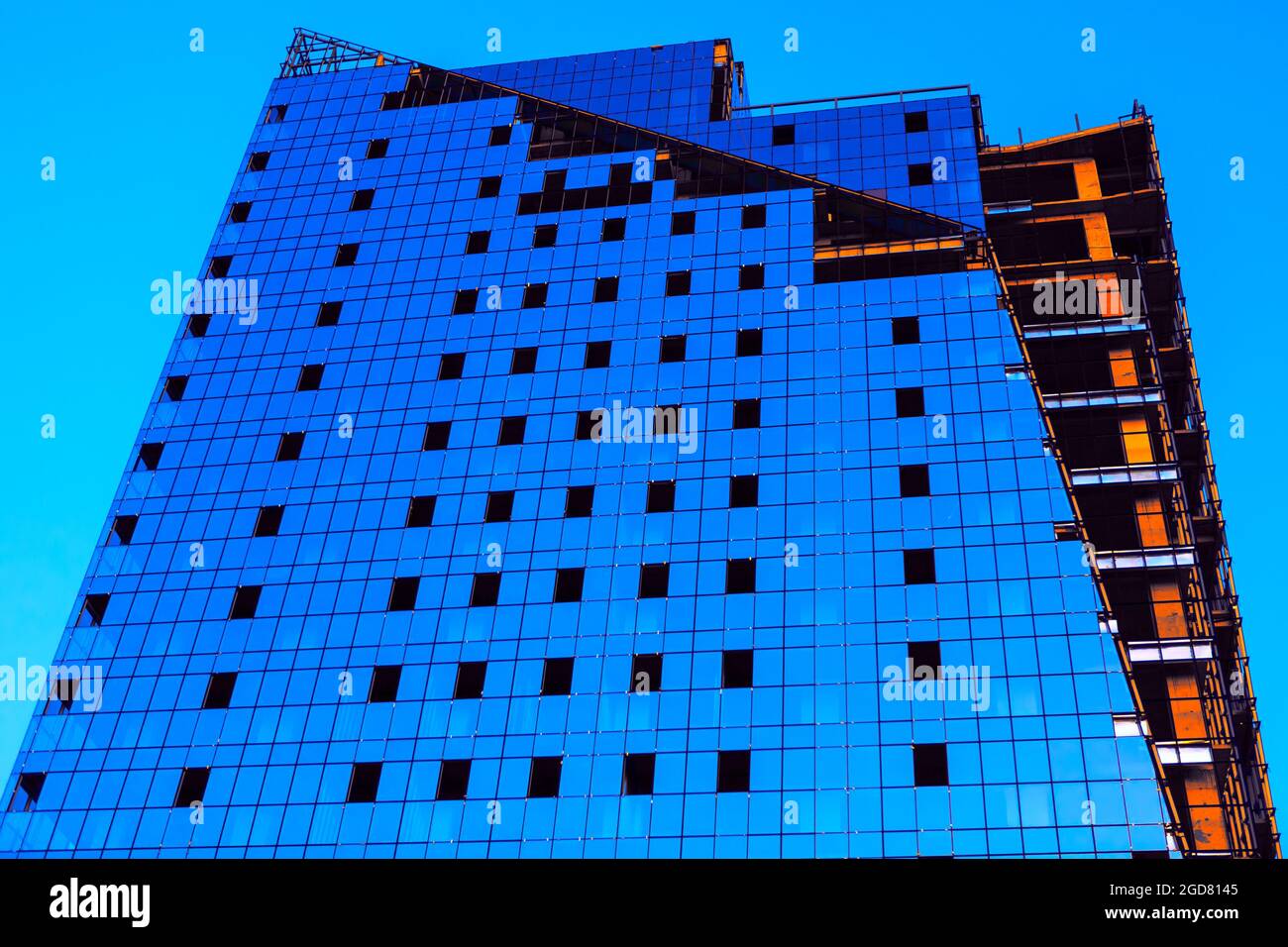Architecture with blue glass facade . Modern house under construction ...