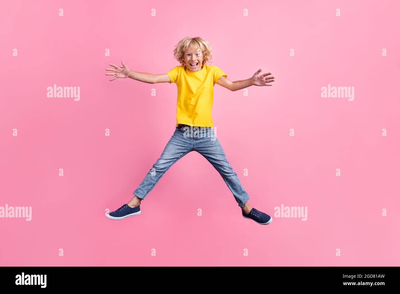 Full length photo of young boy happy positive smile jump open hands hug ...