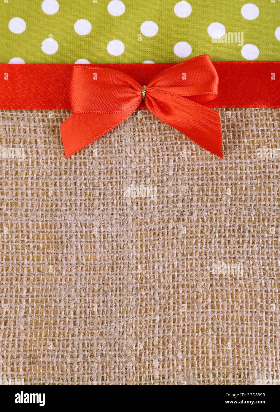 Sackcloth with color ribbon and bow on color fabric background Stock ...