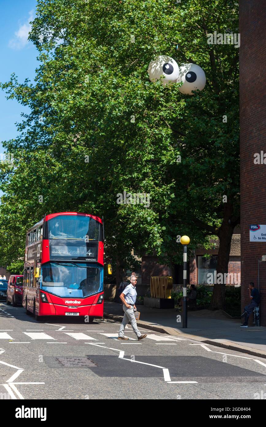 London, UK. 11th Aug, 2021. Giant inflatable googly eyes seen on a tree ...