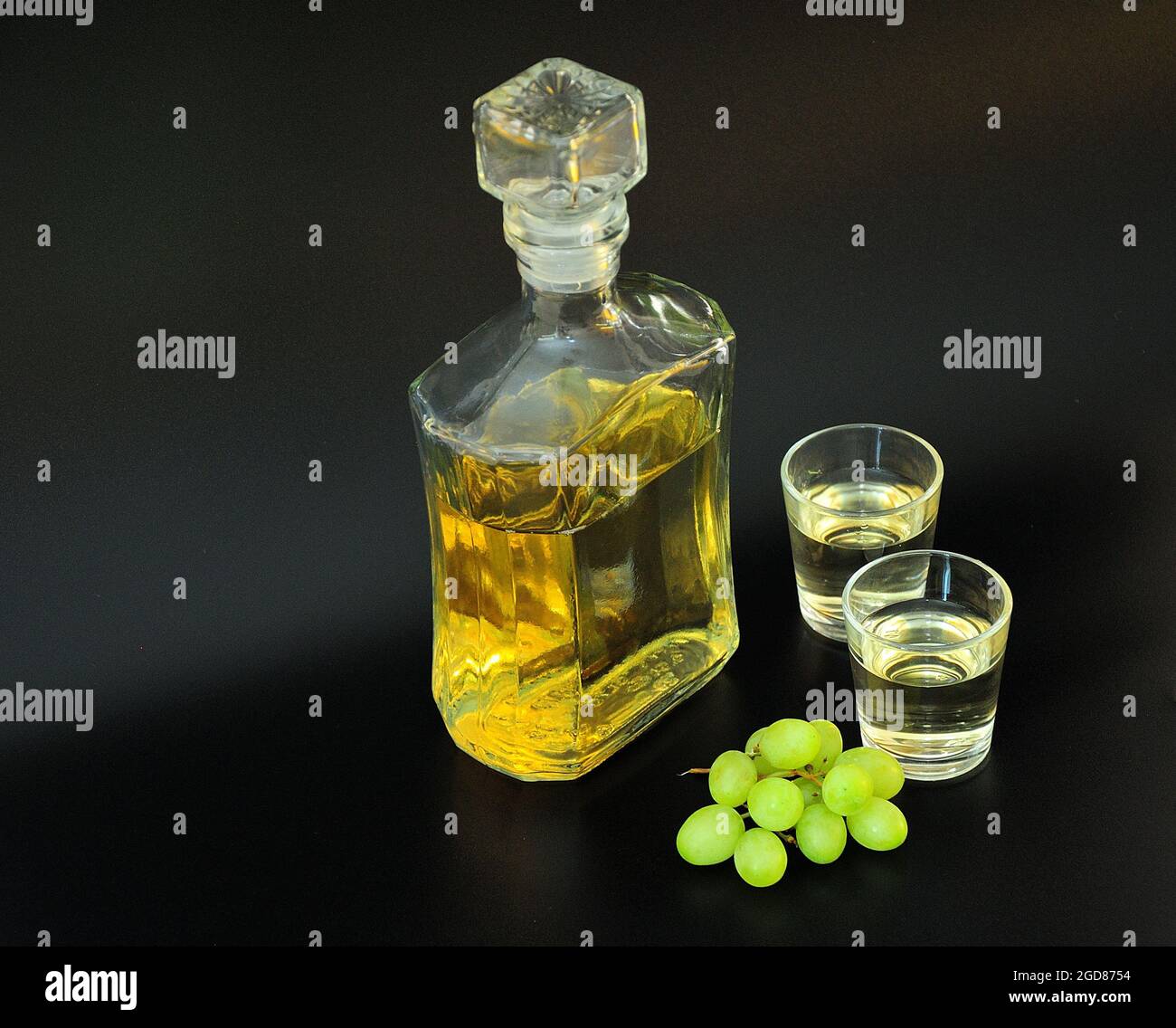 Grappa, a strong alcohol based on white grapes, a glass decanter, two ...
