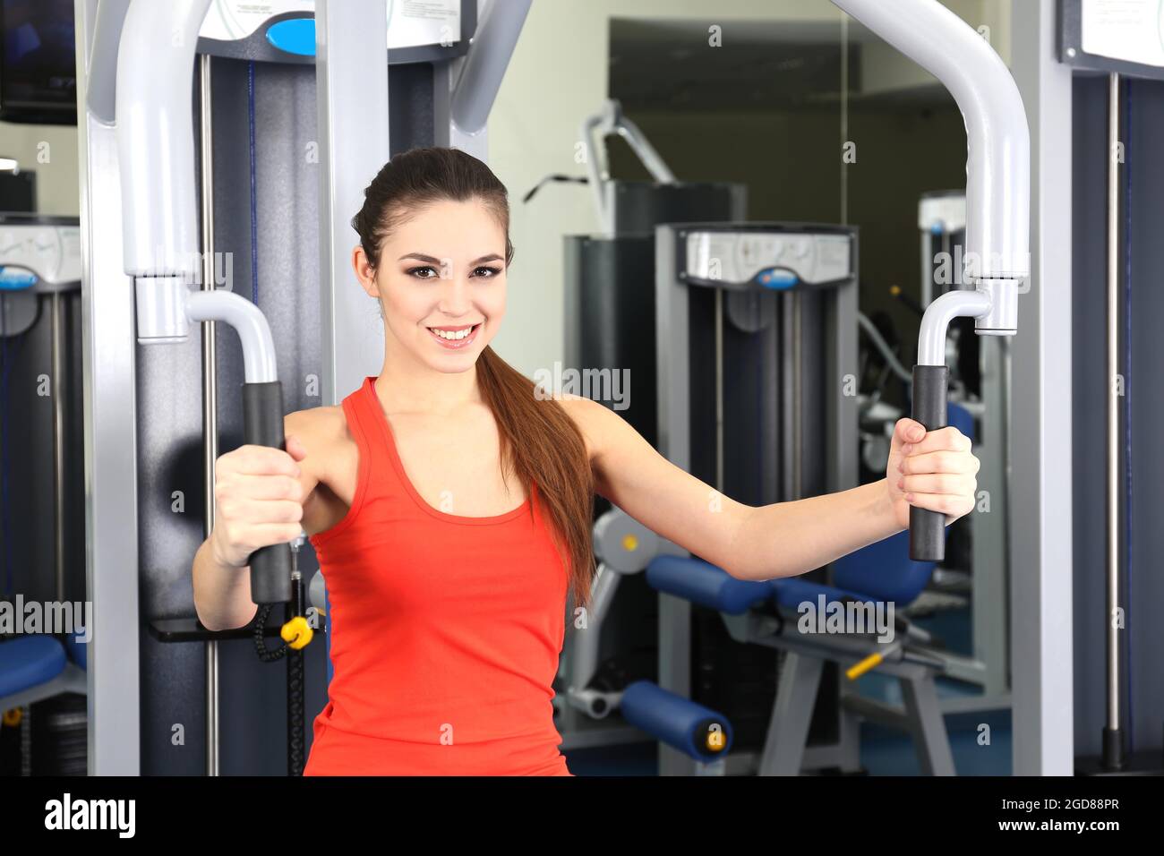 Beautiful woman training with weights in gym Stock Photo - Alamy
