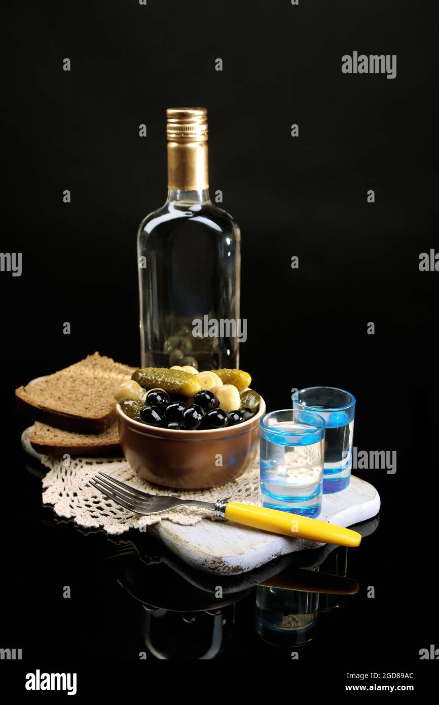 Composition with bottle of vodka, and marinated vegetables, fresh bread ...