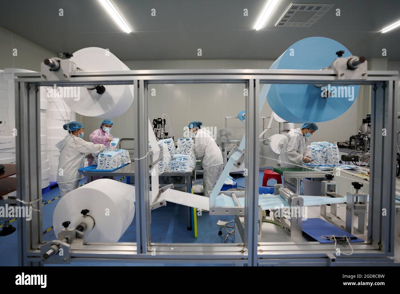 Local staff are busy making facial masks during the Covid-19 rebound in ...