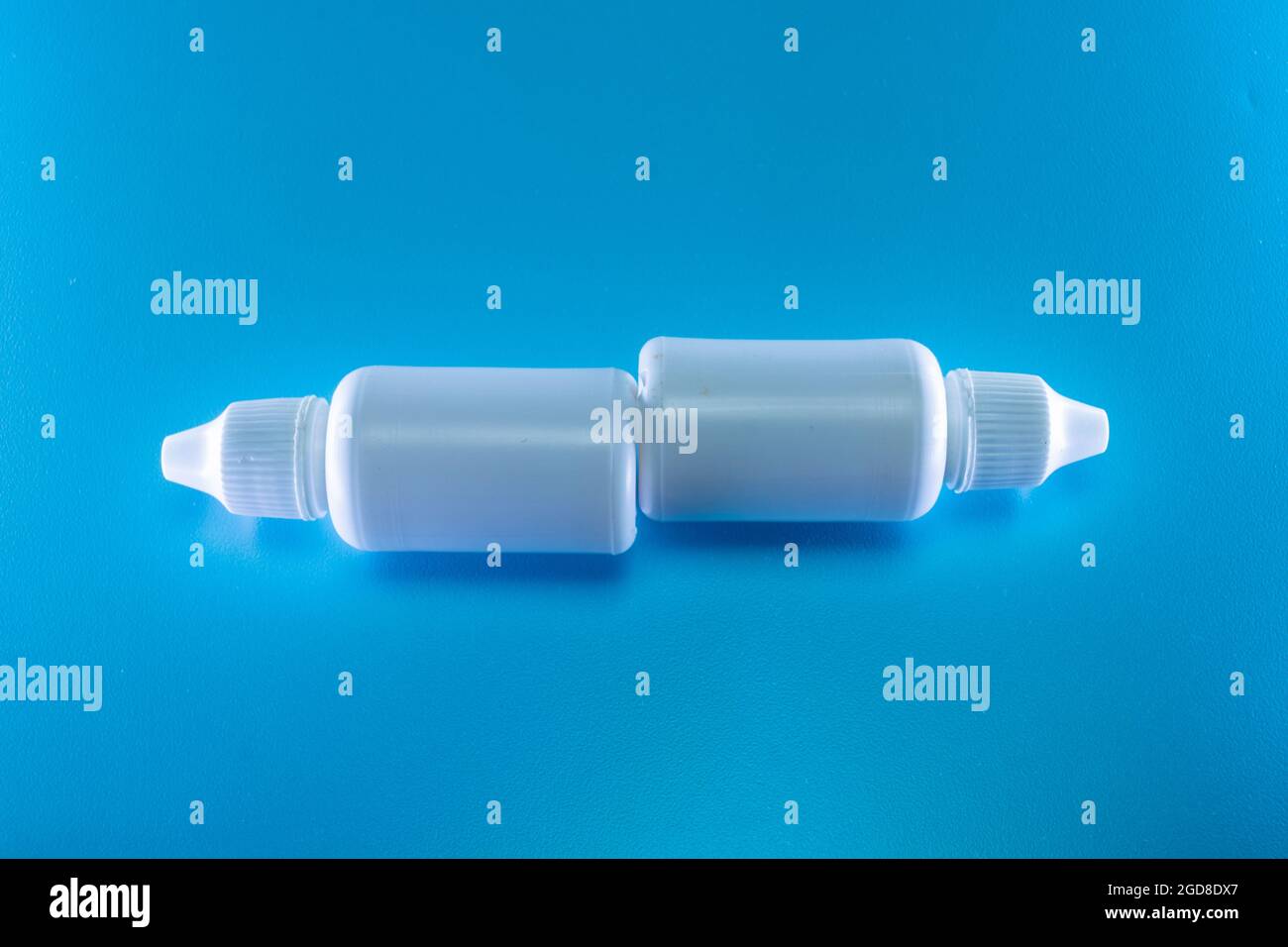 Plastic dropper on blue background hi-res stock photography and images ...