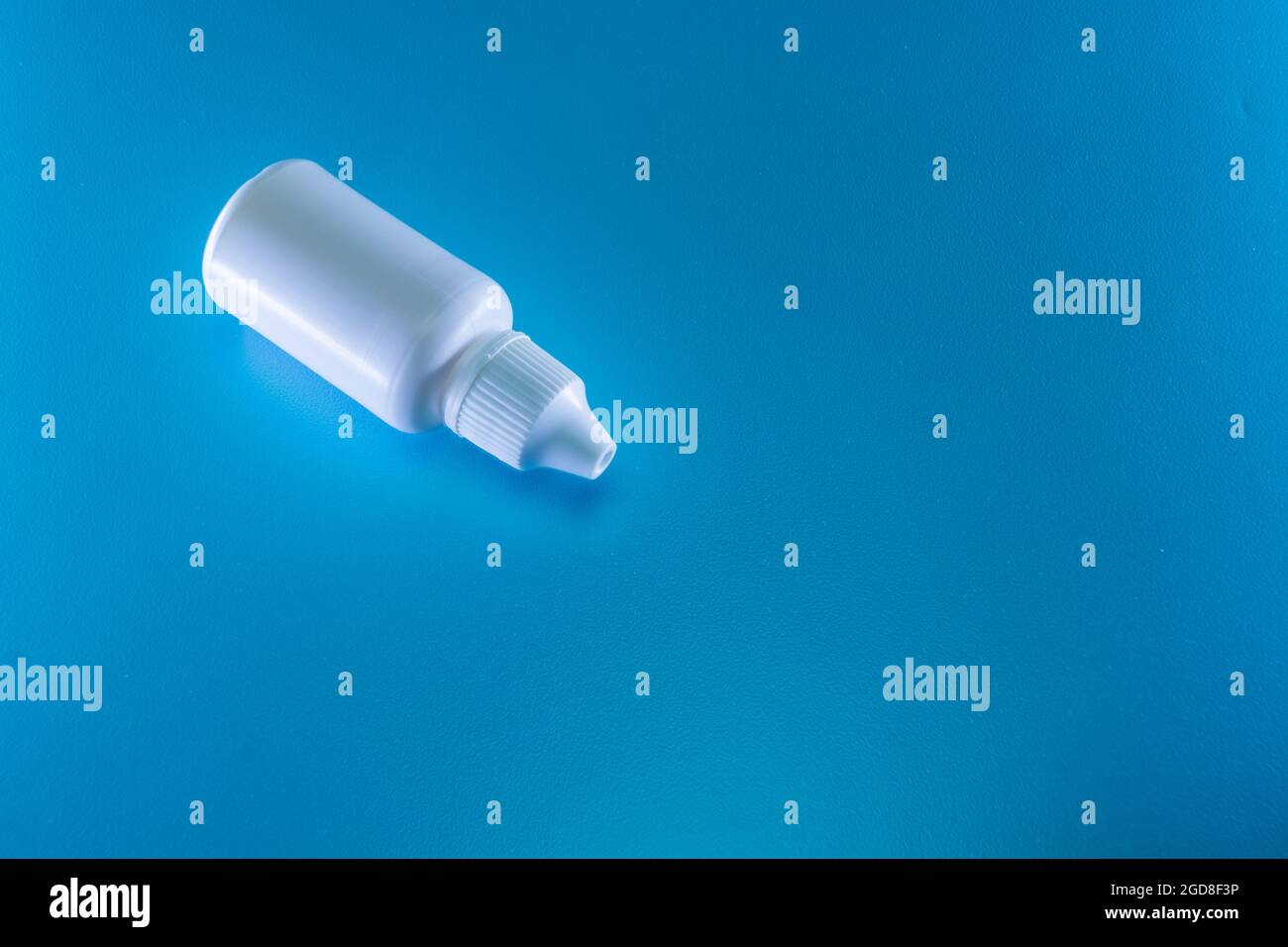 Plastic dropper on blue background hi-res stock photography and images ...