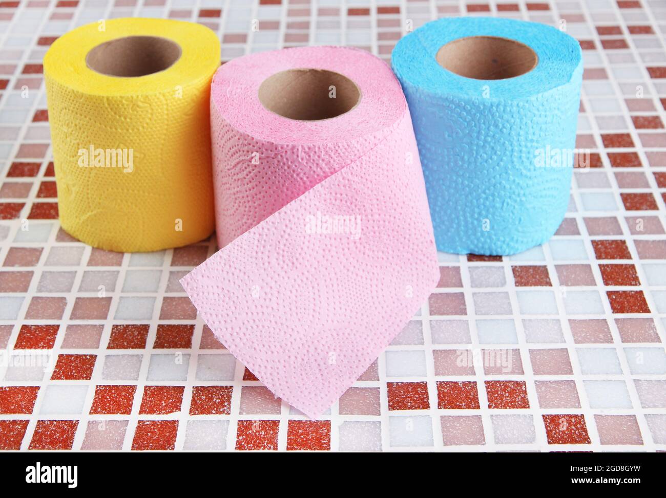 Color toilet paper rolls on bright background Stock Photo - Alamy