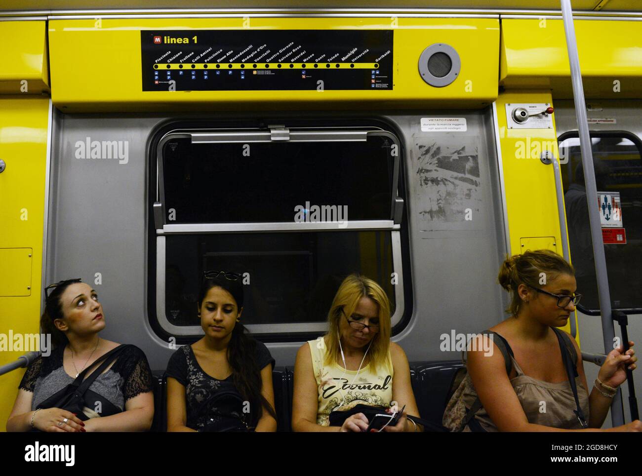 Passengers sitting in line 1 in Naples metro Stock Photo - Alamy