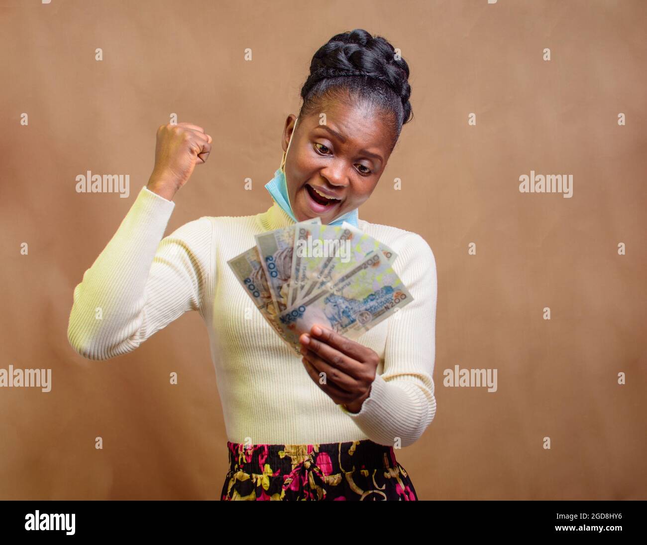 Woman holding currency notes showing hi-res stock photography and ...