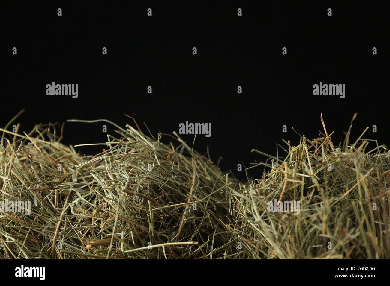 Hay on dark background Stock Photo - Alamy