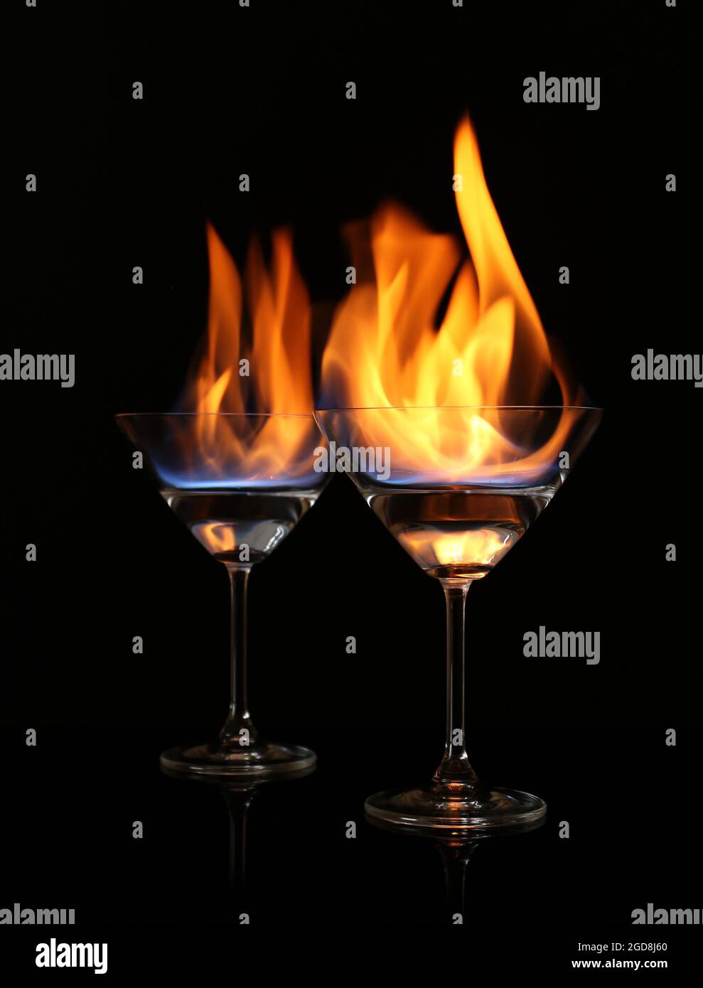 Glasses with burning alcohol on black background Stock Photo - Alamy
