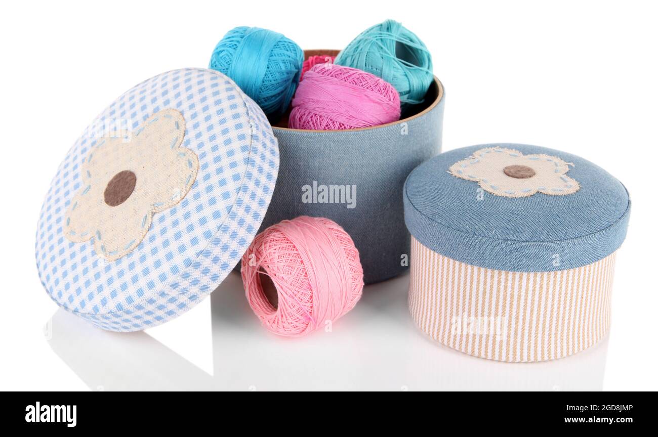 Decorative boxes with colorful skeins of thread isolated on white Stock ...