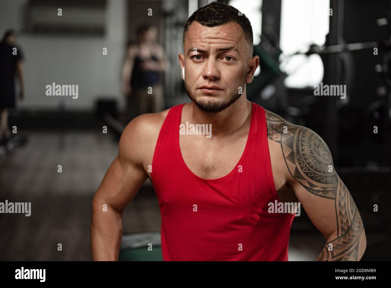 Portrait of man bodybuilder in red shirt in gym Stock Photo - Alamy