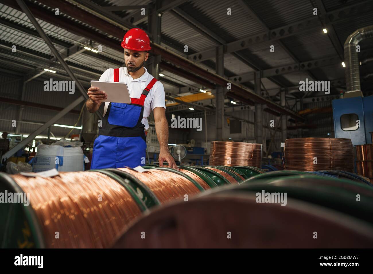 African american male manager in electric cable warehouse holding ...