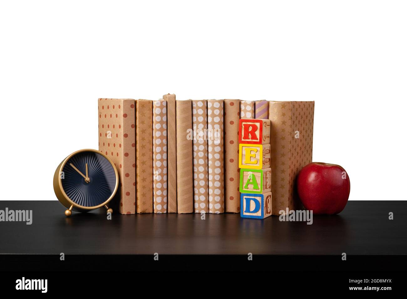 Stack of books and apple on tabletop against white background Stock ...
