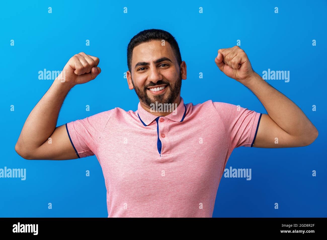Young arab successful man celebrating triumph in studio Stock Photo - Alamy
