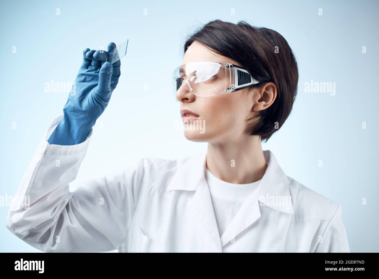female laboratory assistant in a white coat analysis diagnostics ...