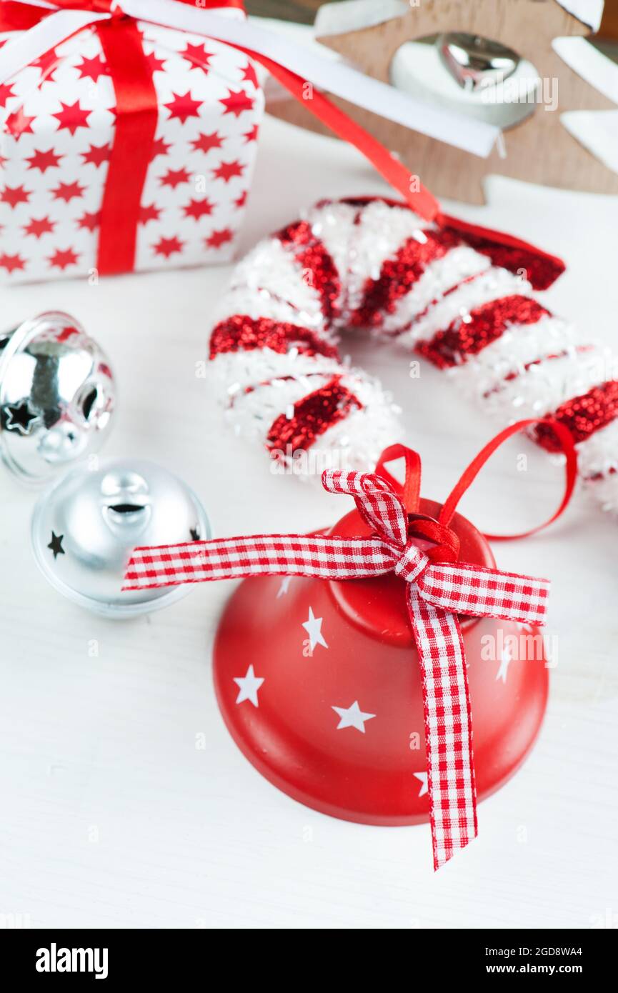 Christmas red bell and xmas stick. Modern lifestyle composition in ...