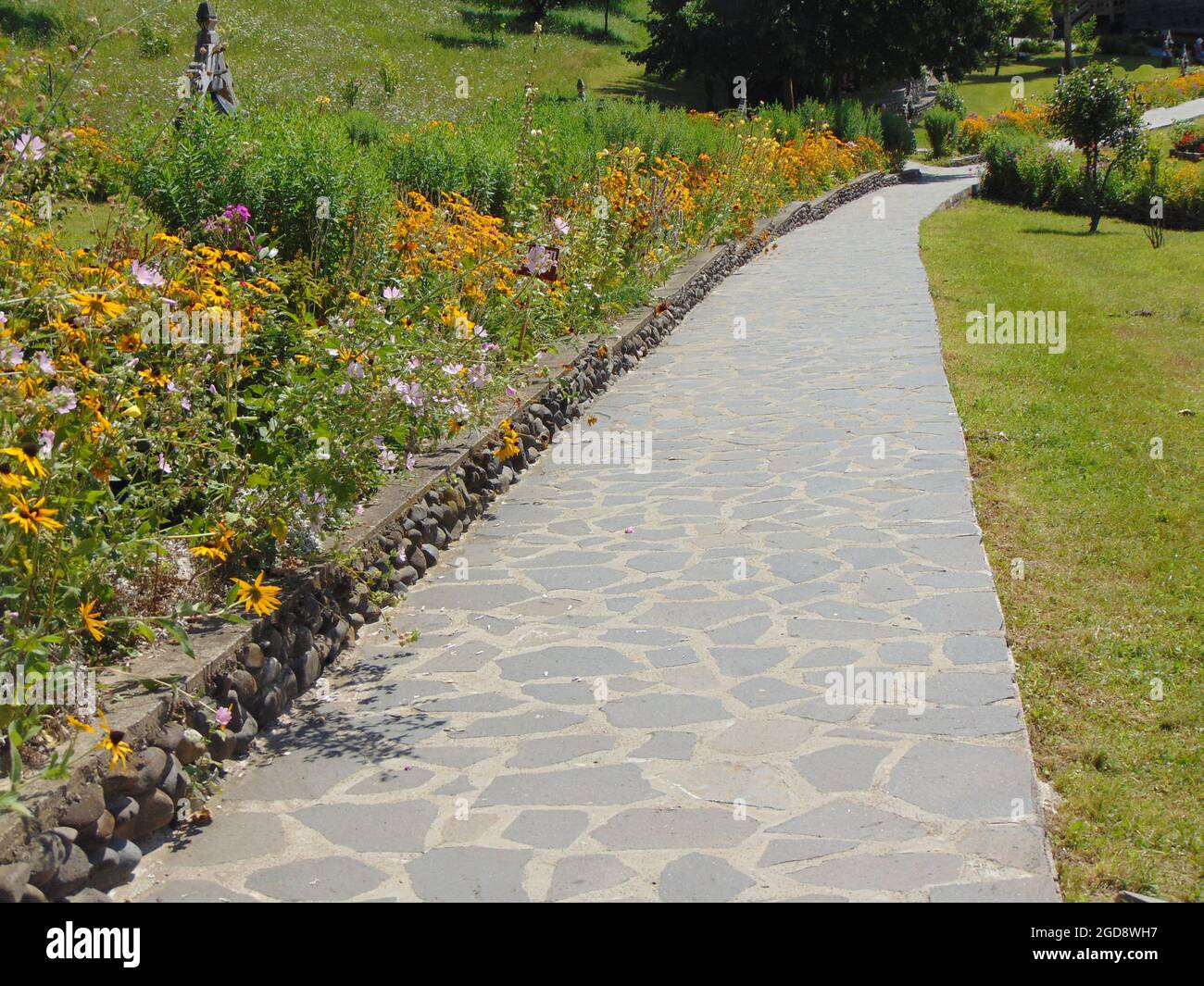 alley and flowers at Barsana orthodox monastery, Maramures Stock Photo ...