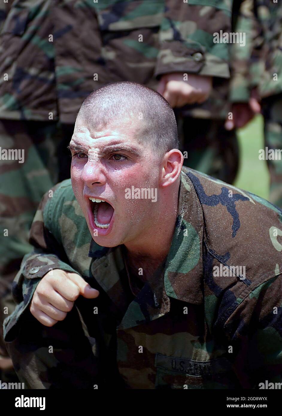 A US Army (USA) trainee yells encouragement to a platoon member in a ...
