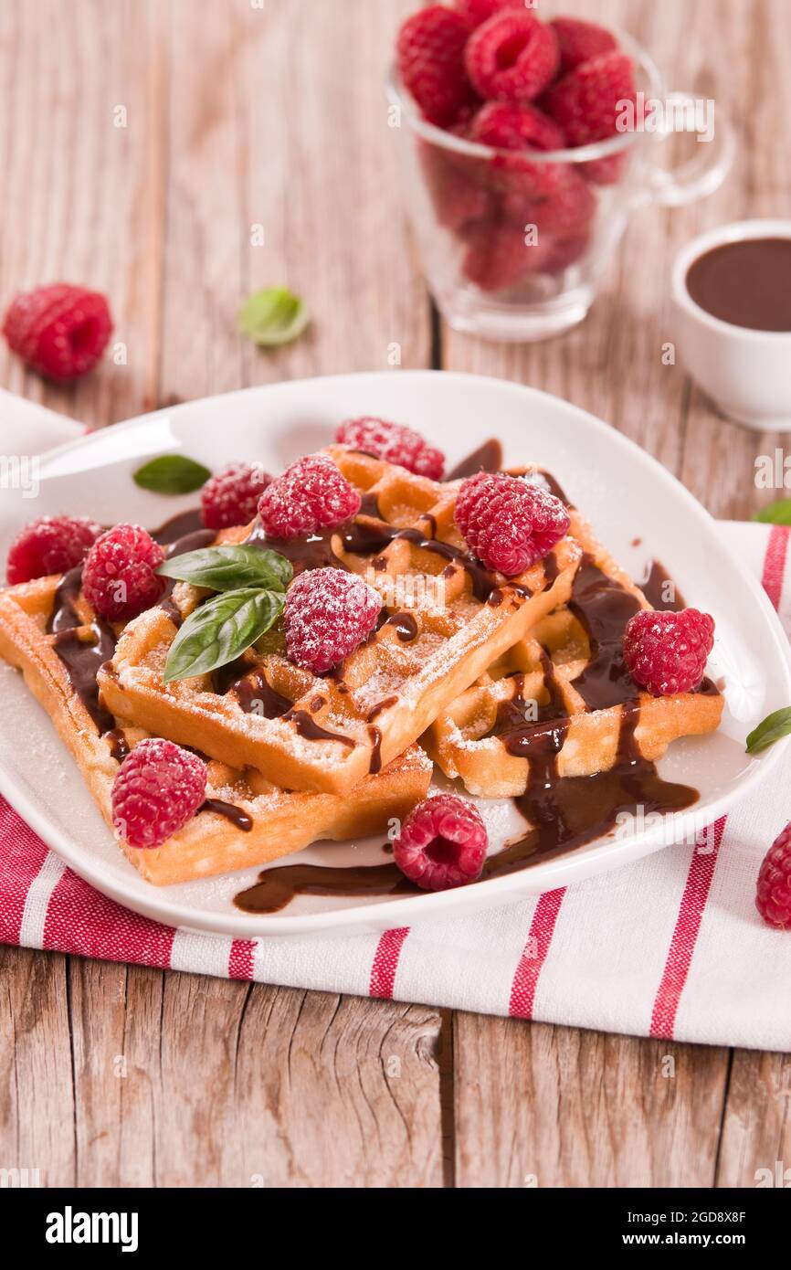 Waffles with raspberries and chocolate cream Stock Photo - Alamy