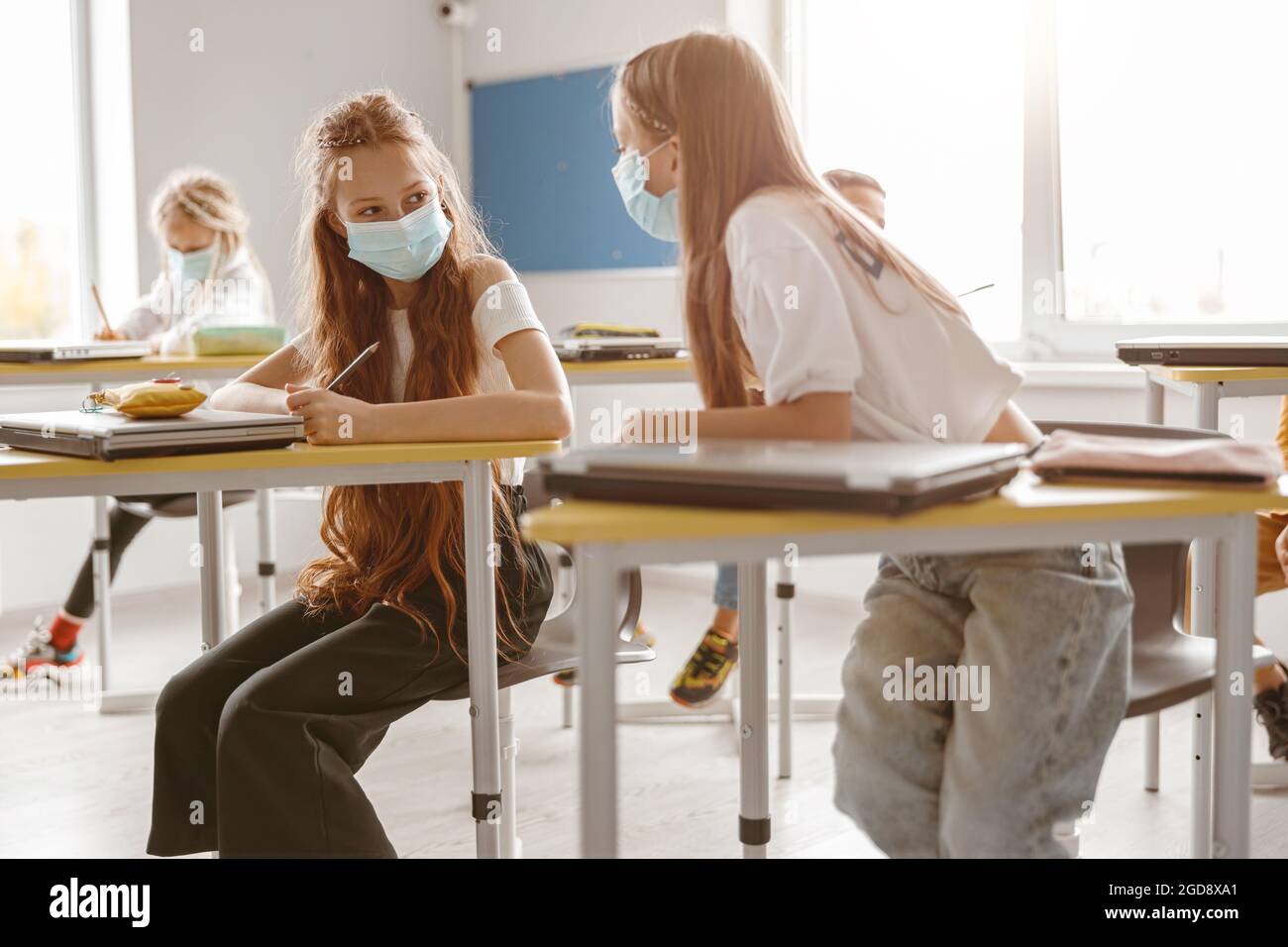 Kids using pencils and notebooks while writing test together in school ...
