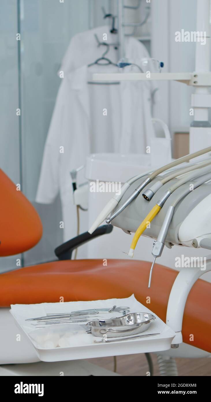 Revealing shot of orthodontist dentistry chair with nobody in, prepared ...