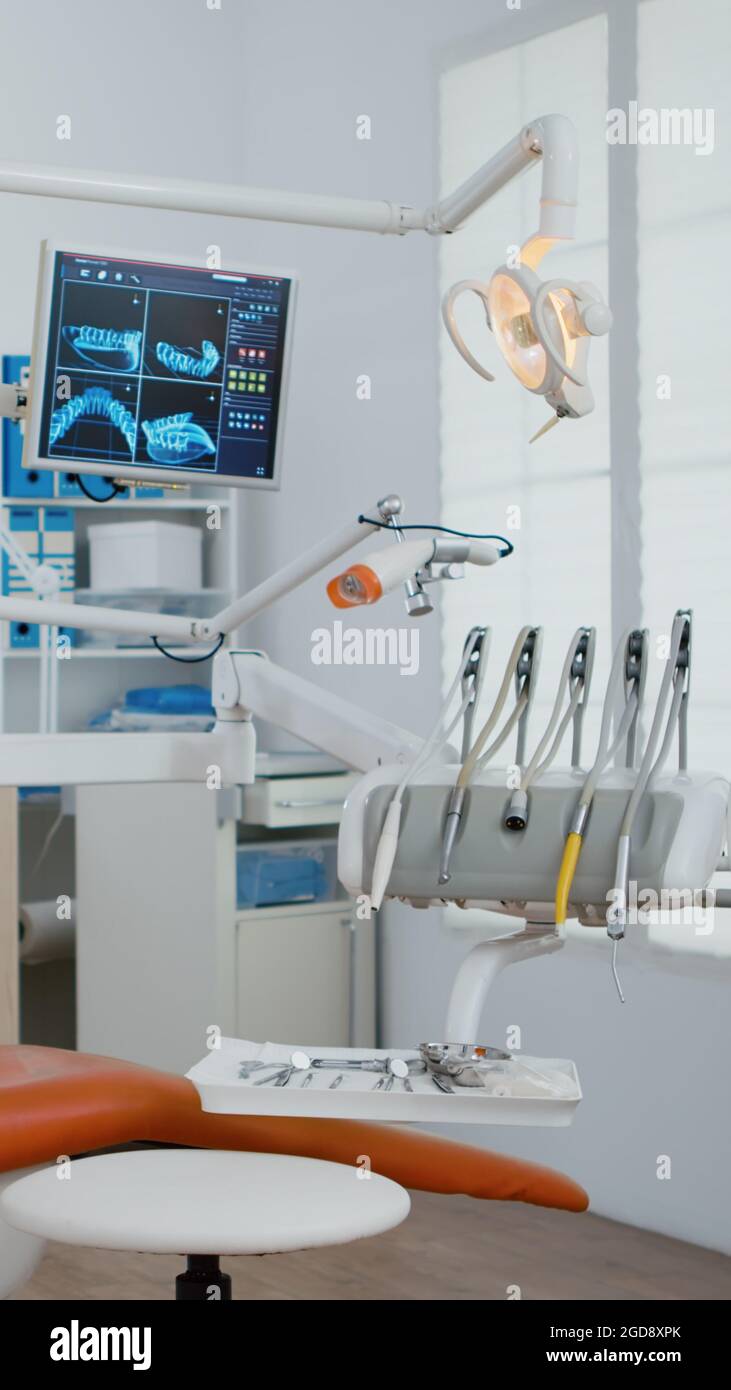 Interior of modern equipment oral office with teeth x ray on monitors ...
