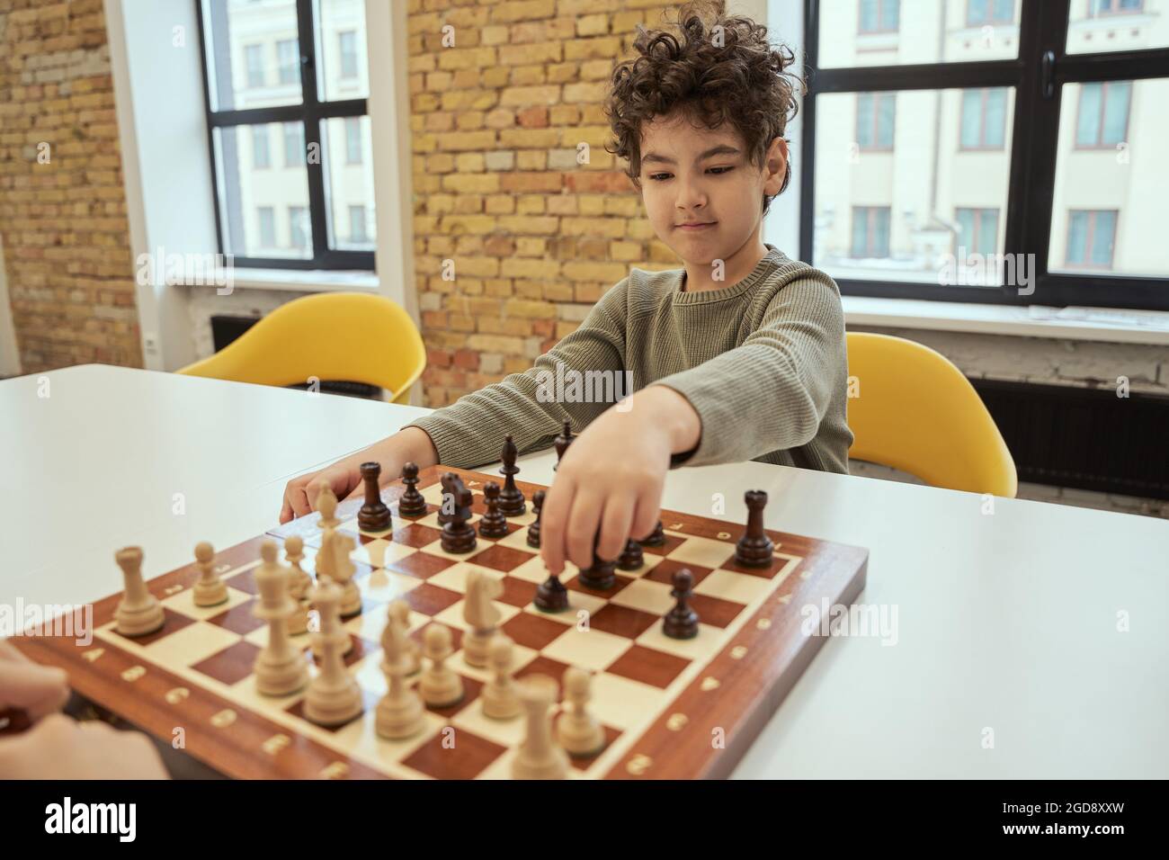 Good move. Observant little boy making a move while sitting in the ...