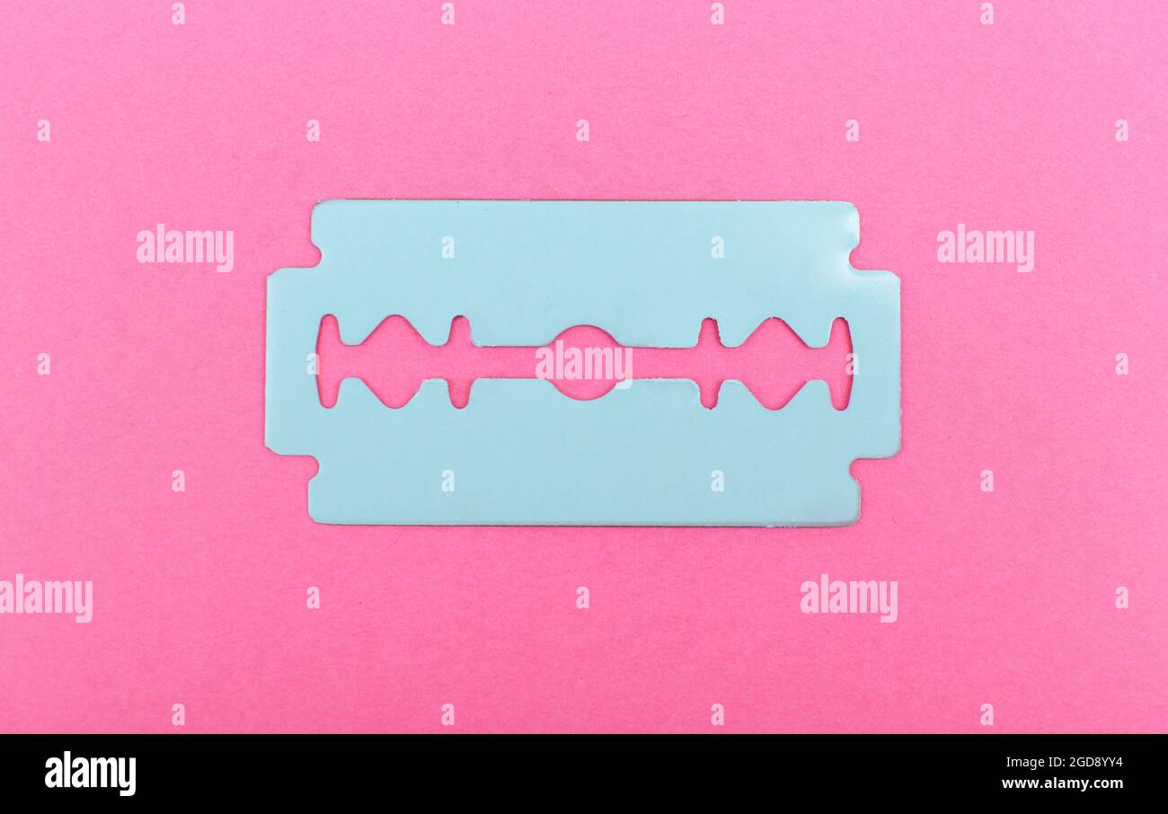 Razor blade on color background Stock Photo - Alamy