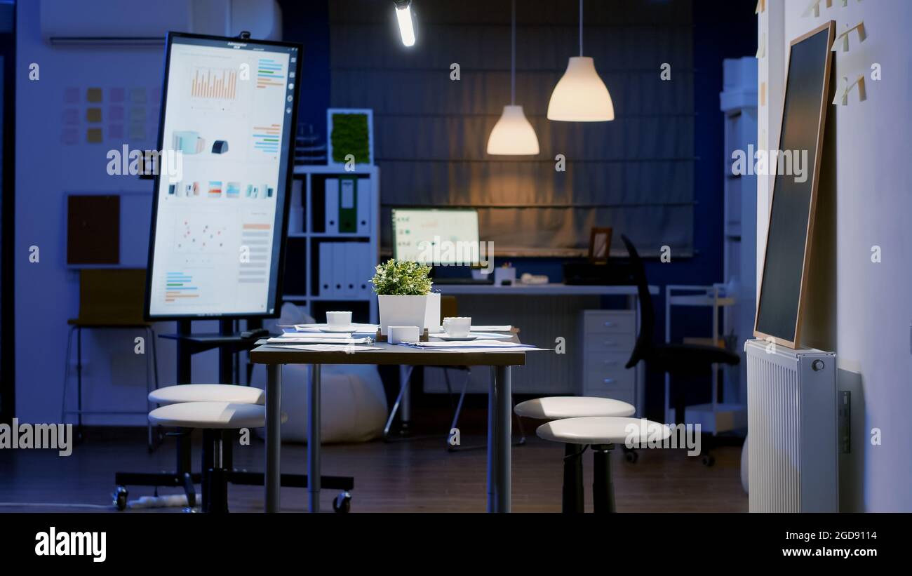 Interior of professional empty start-up business office meeting room with nobody in it. On table ...