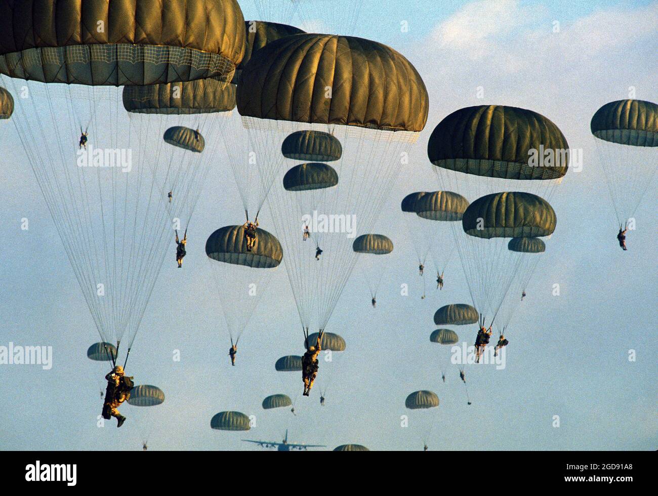 Members of the 82nd Airborne Division parachute from a C-130 Hercules ...