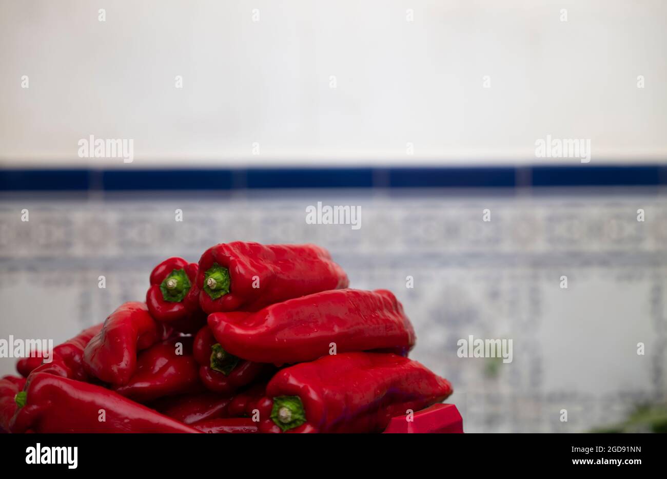 Group of red peppers against white and blue ceramic wall Stock Photo ...