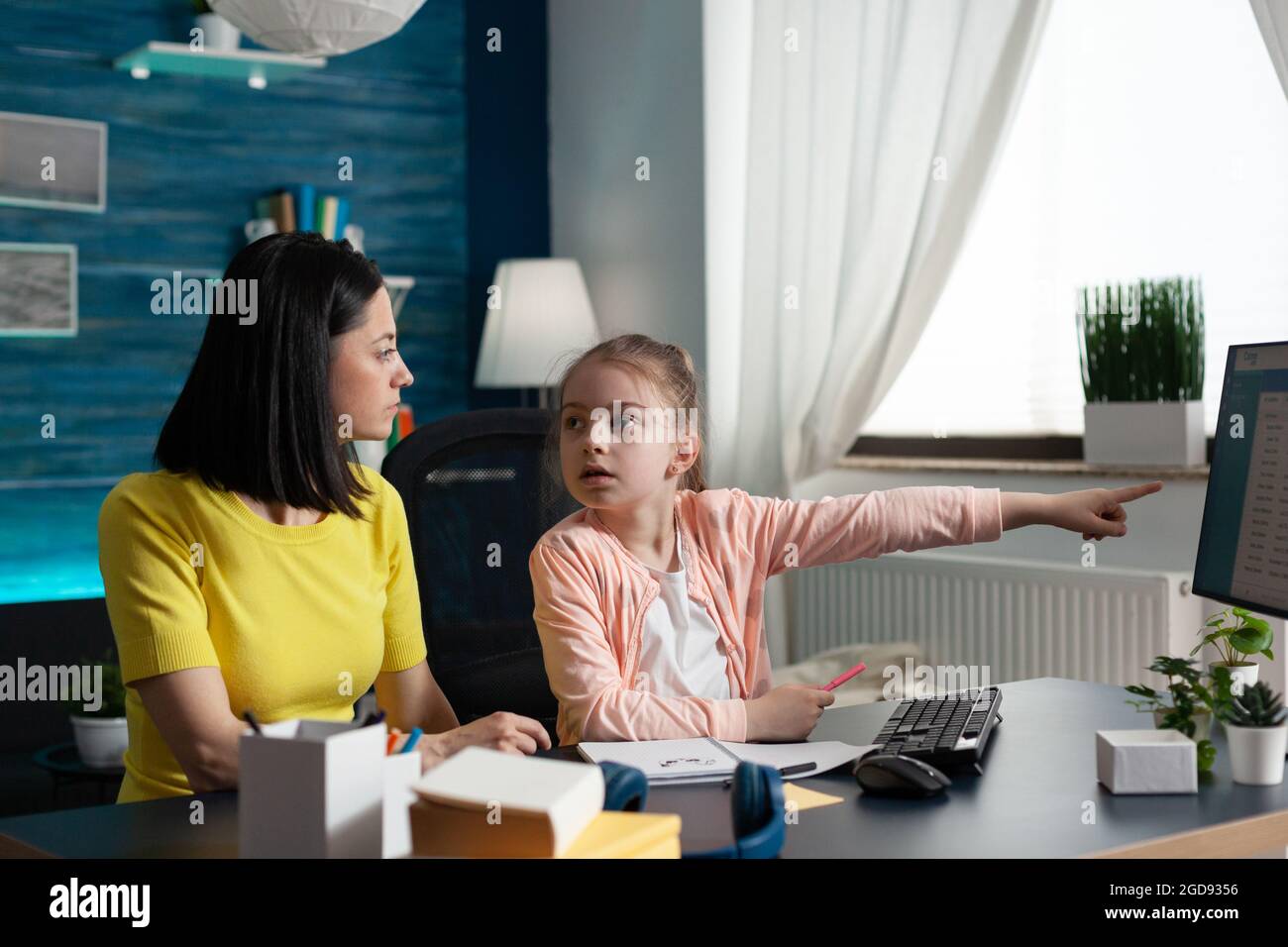 Small student studying with parent on internet for elementary ...