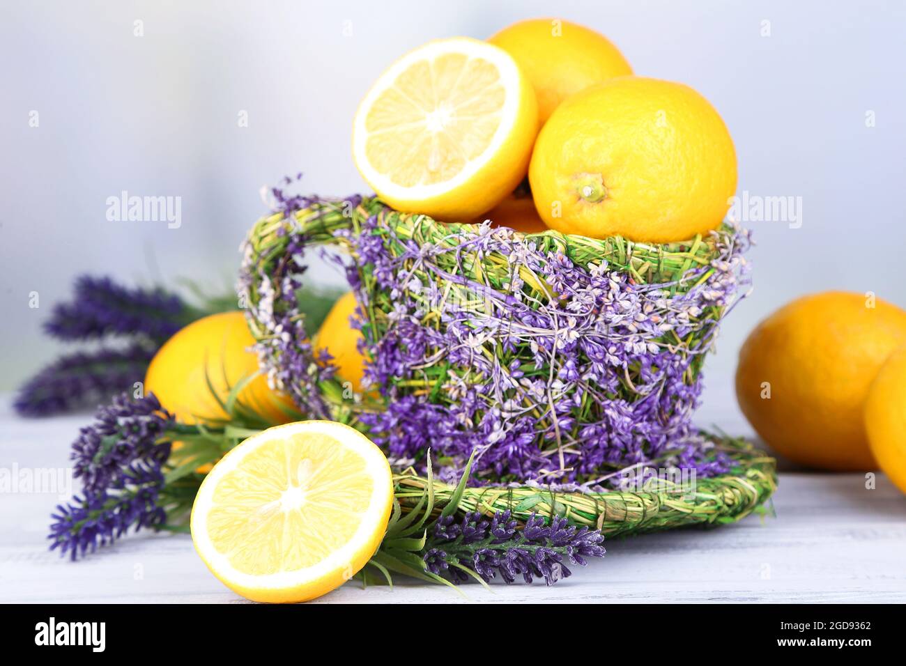 Still life with fresh lemons and lavender on light background Stock ...