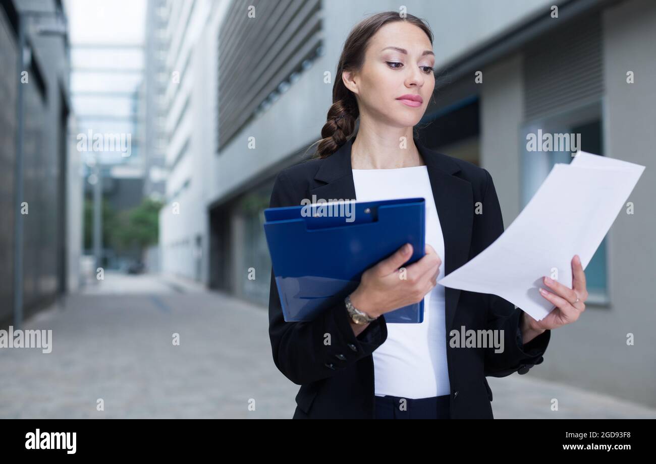 Female creative director is examining documents Stock Photo - Alamy