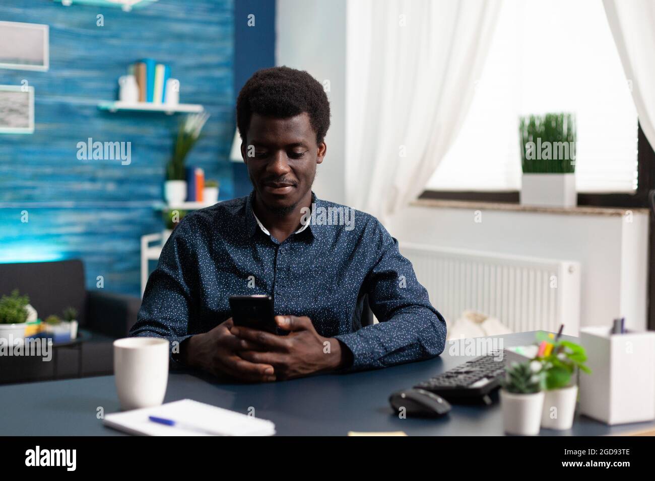 Man of african american ethnicity using telephone and smiling while ...