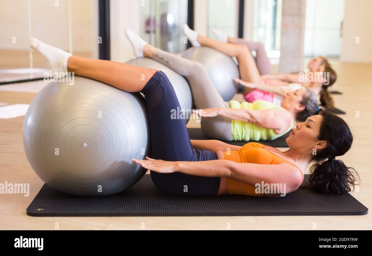 Asian woman with pilates ball doing exercises for press Stock Photo - Alamy