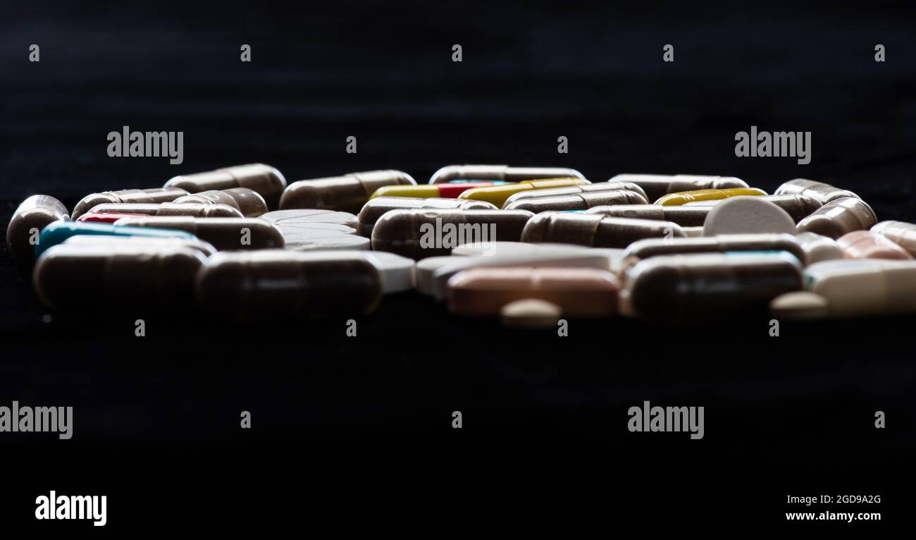 Starch capsule pills and tablets dark background, drugs Stock Photo - Alamy
