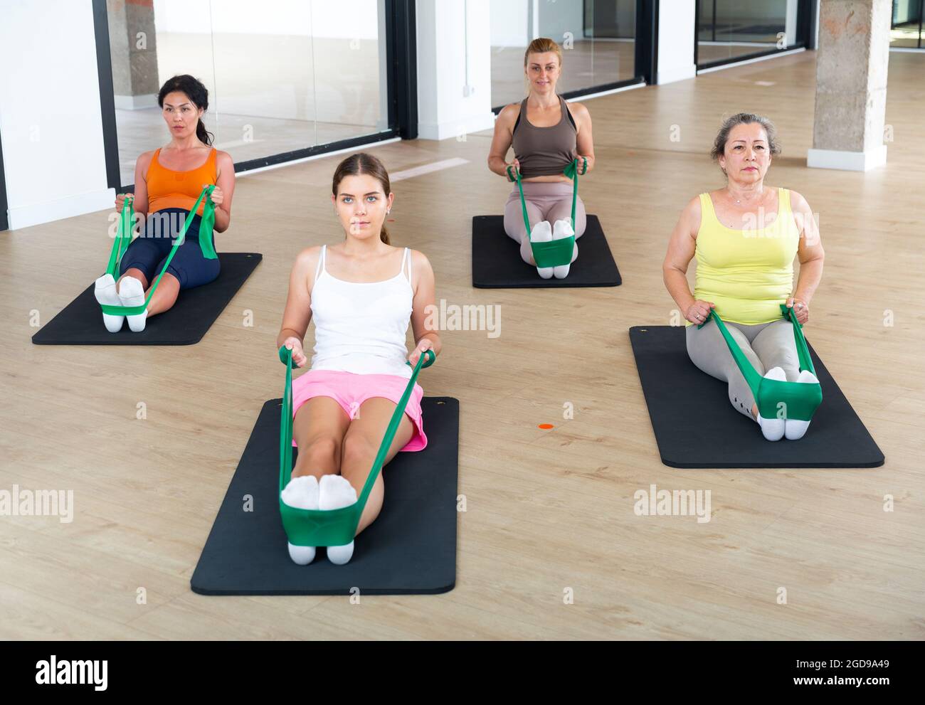 Women doing pilates exercise with expander tape Stock Photo Alamy