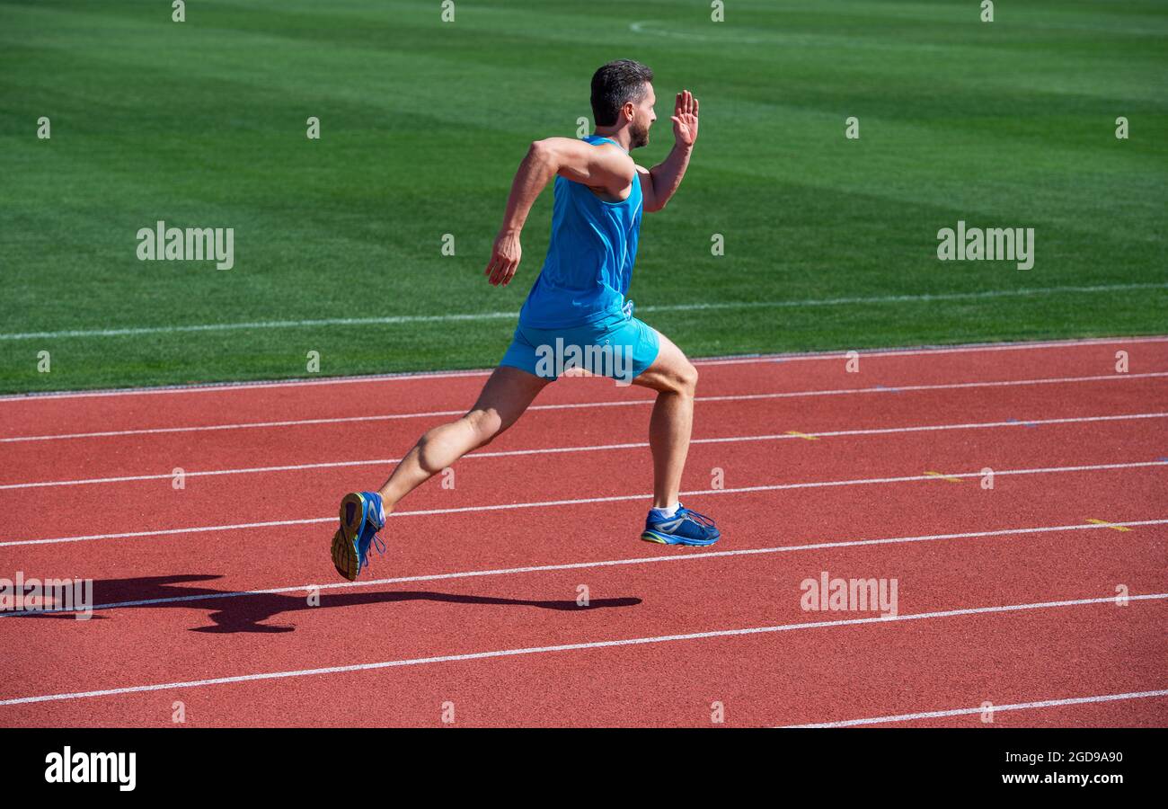 athletic muscular man runner running on stadium, energy Stock Photo - Alamy