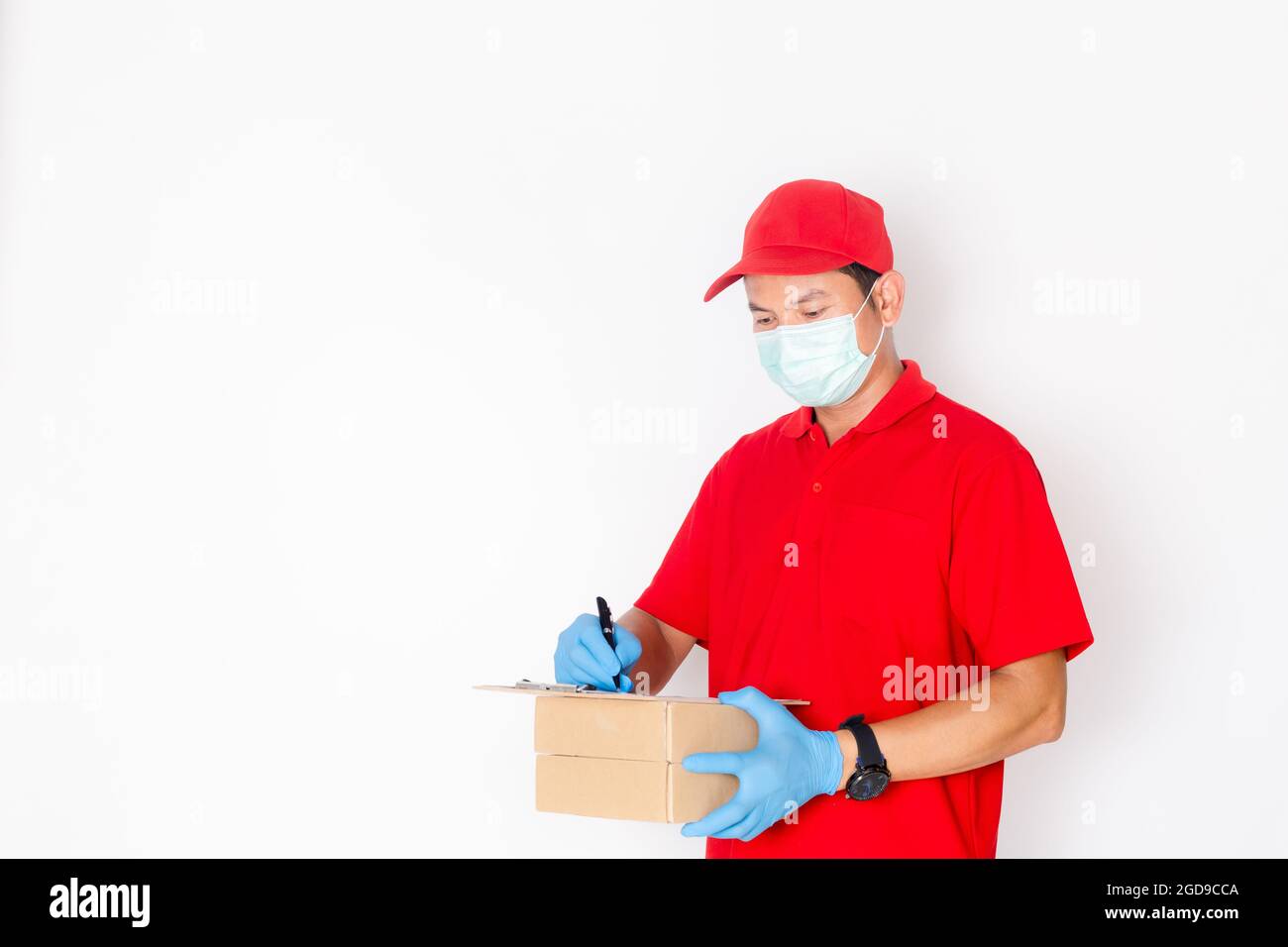 Delivery guy wearing red uniform hi-res stock photography and images ...