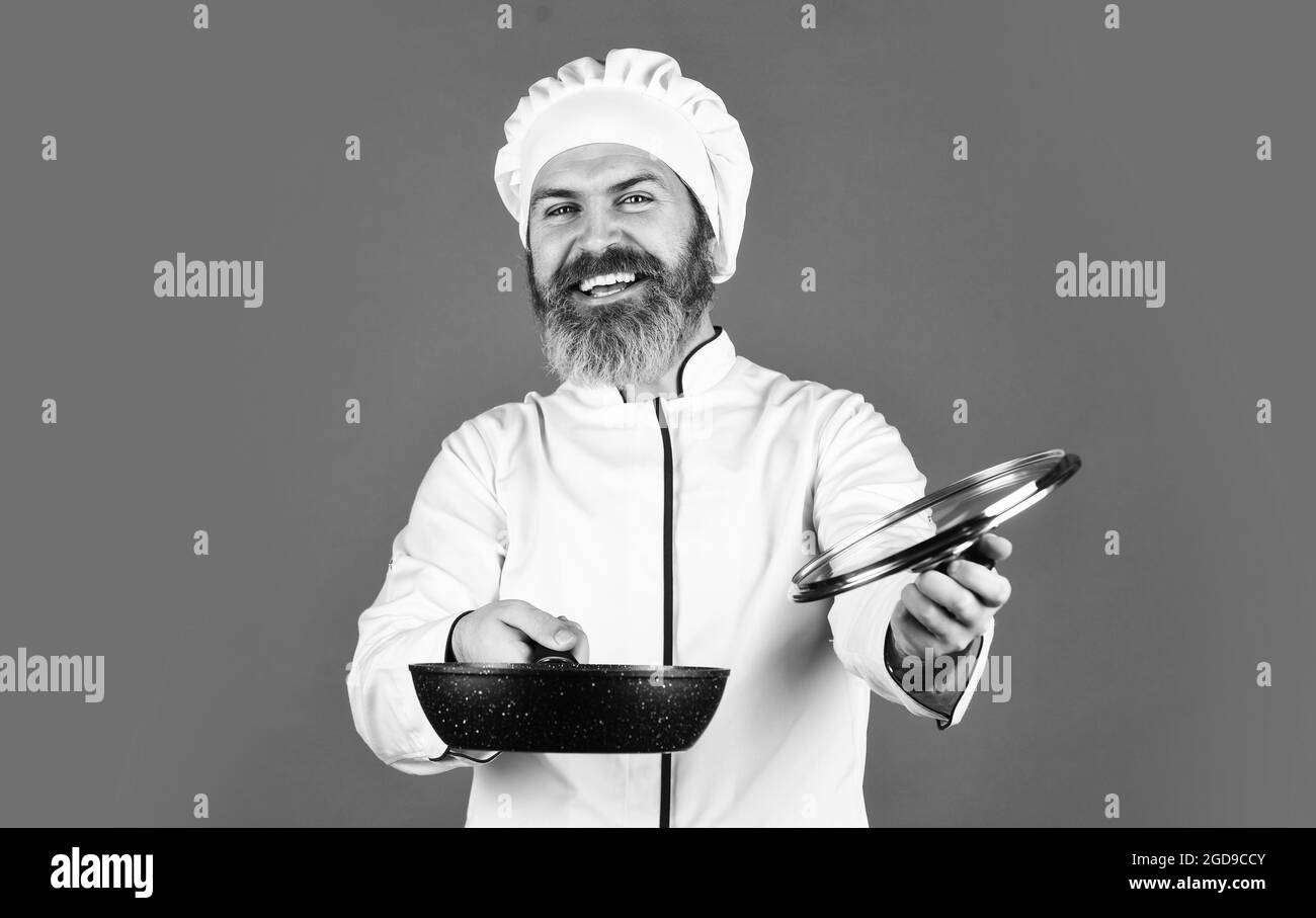 High quality frying pan. Bearded man cook white uniform. Homemade ...