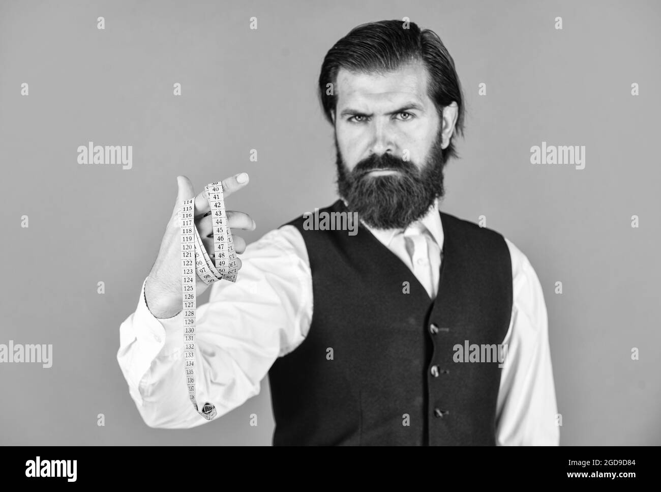 Talented tailor. man tailor with tape measure and scissors. man ...