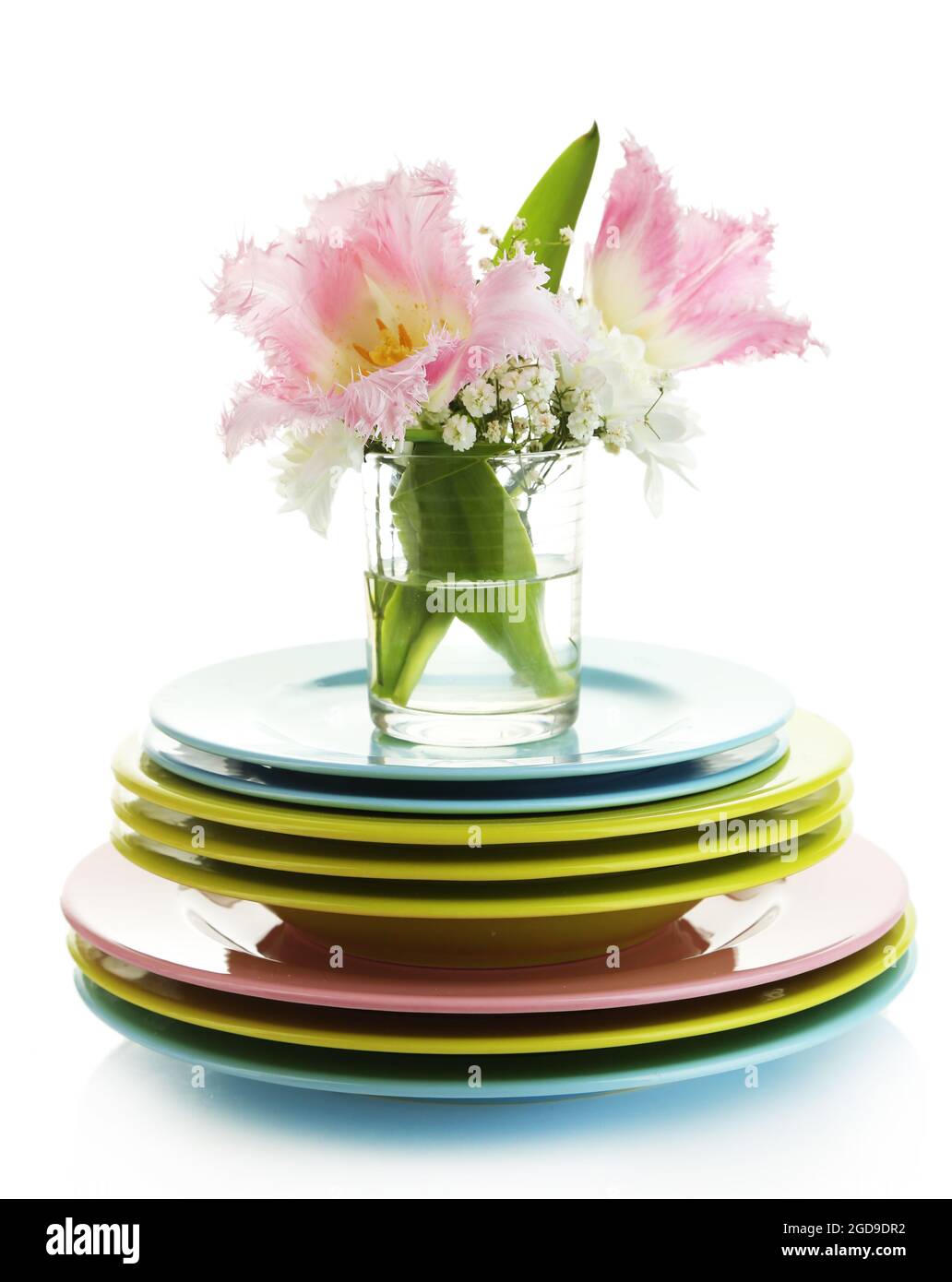 Stack of colorful ceramic dishes and flowers, isolated on white Stock ...