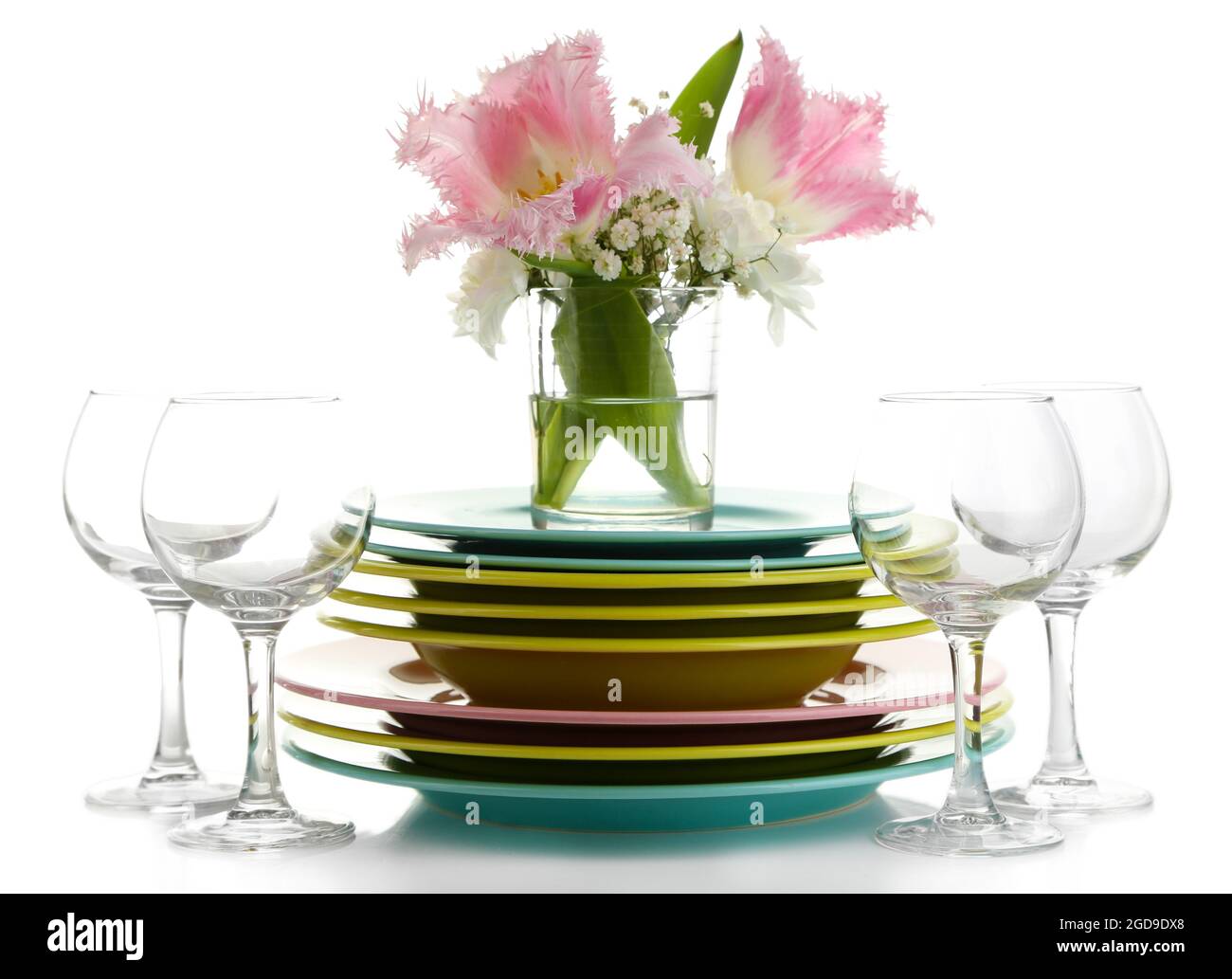 Stack of colorful ceramic dishes and flowers, isolated on white Stock ...