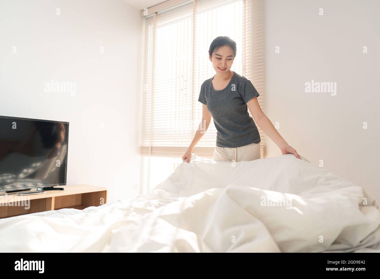 Bedroom concept a female adult doing the routine by grabbing the edge ...