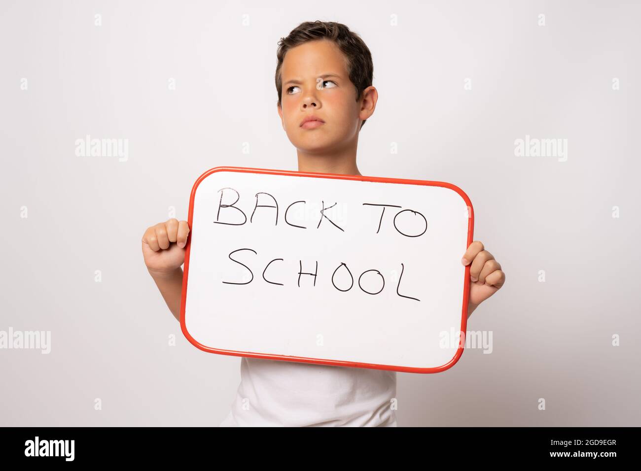 Smiling male student holding signboard isolated over white background ...